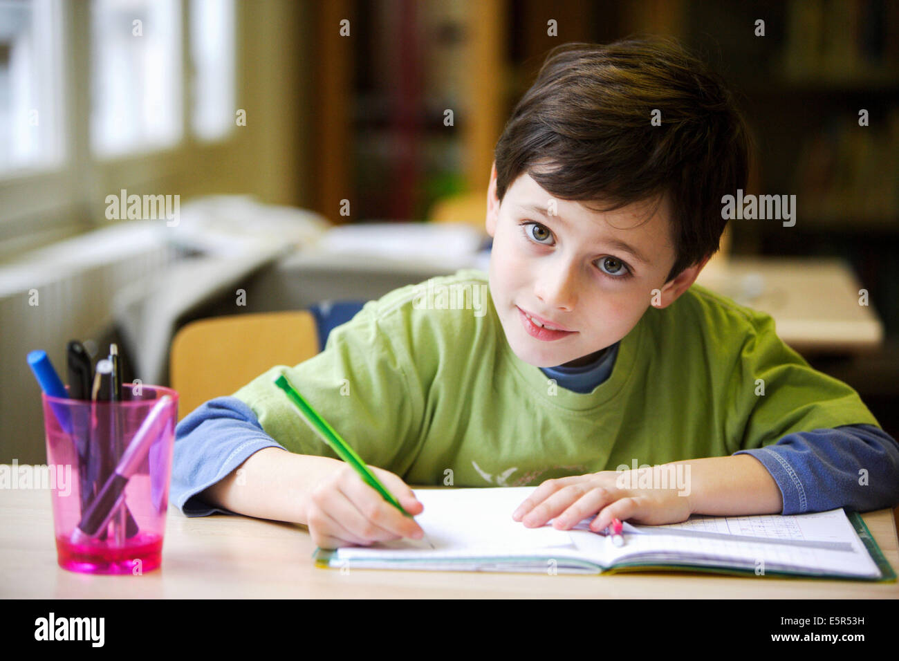 8 year old boy doing his homework Stock Photo - Alamy