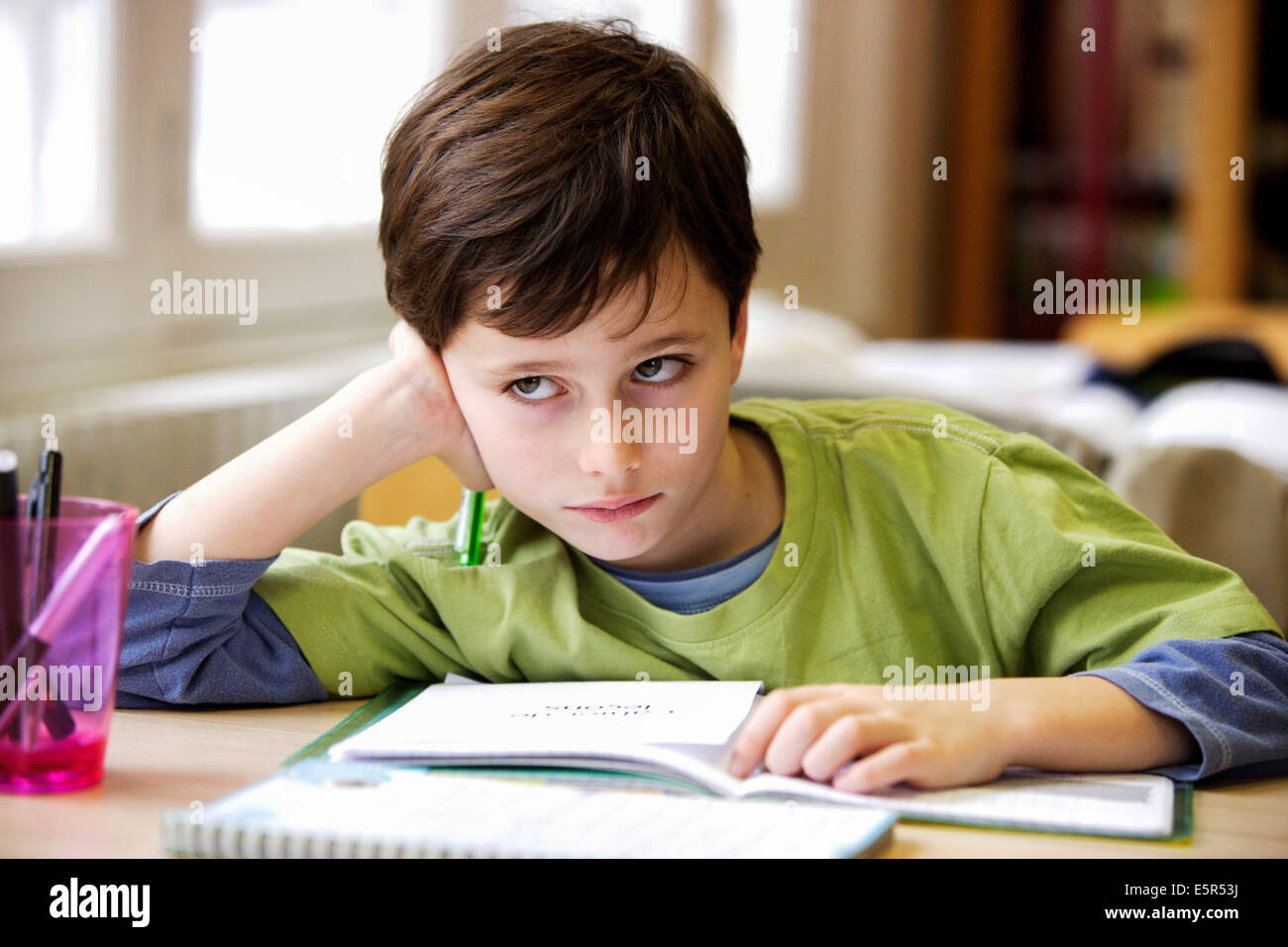 8 year old boy doing his homework Stock Photo - Alamy