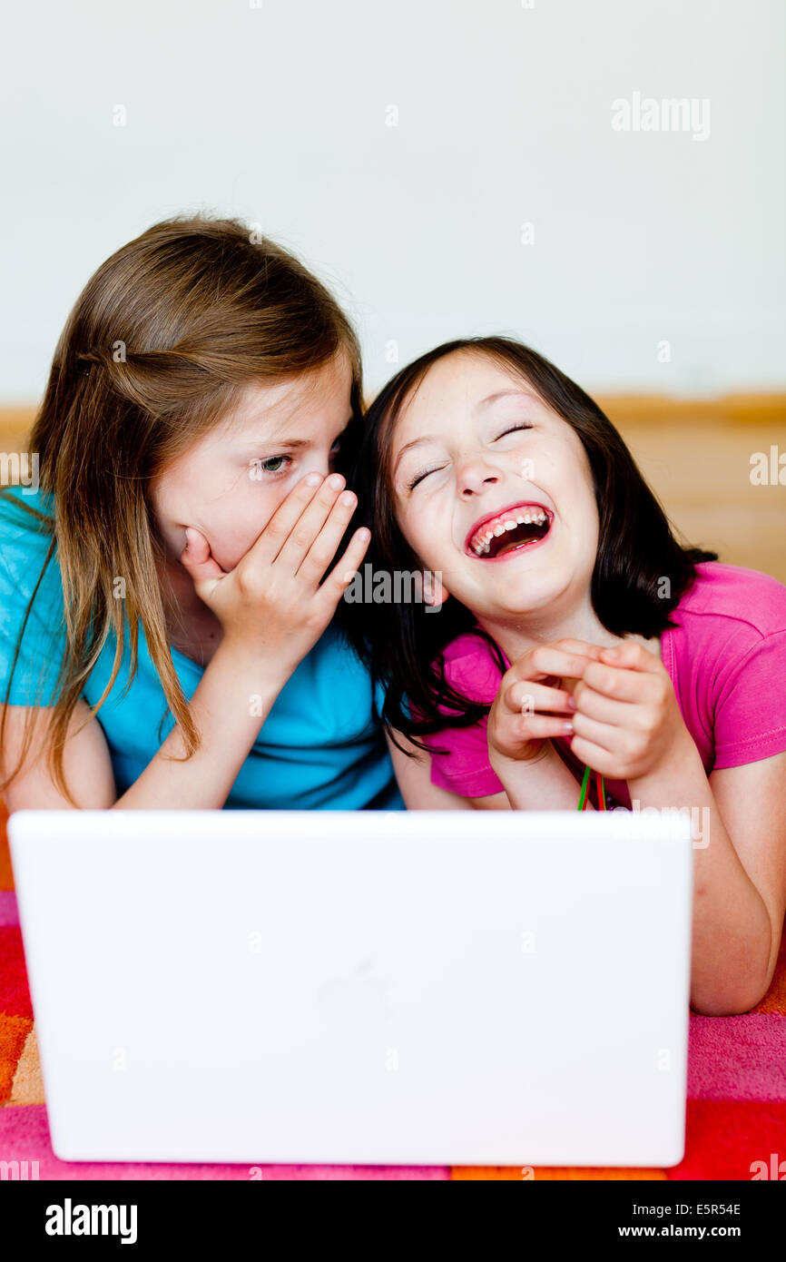 7 and 11-year-old sisters using laptop computer Stock Photo - Alamy