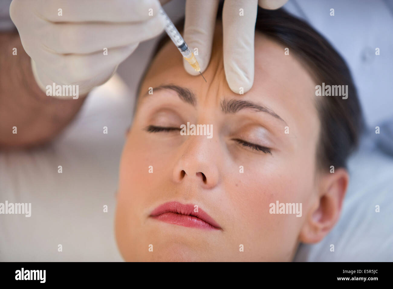 Woman receiving Botox injections for treatment of lion's wrinkles Stock ...
