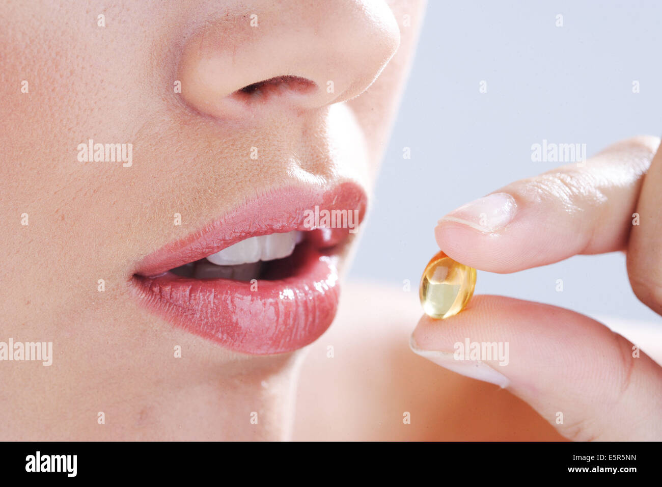 Woman taking food supplement capsules Stock Photo - Alamy