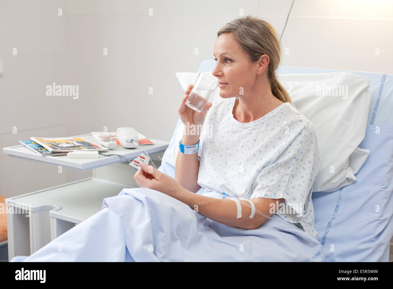 Hospitalized woman taking medicine Stock Photo - Alamy