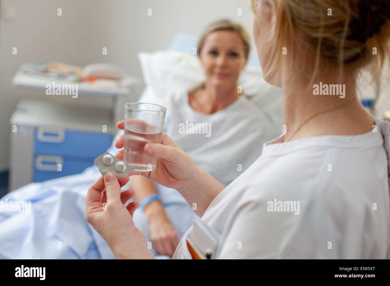 Nurse giving medication to a patient at hospital, Limoges hospital ...