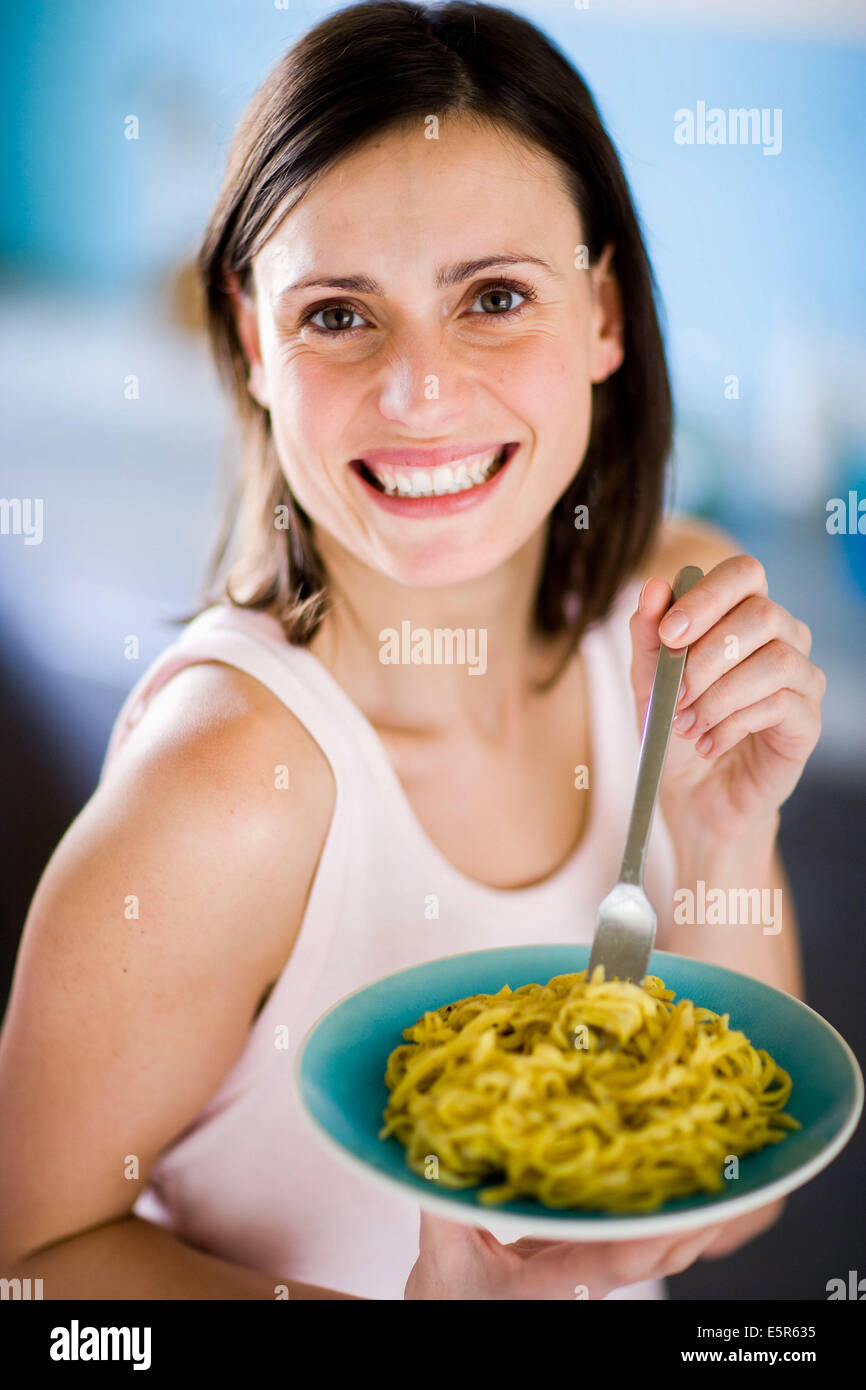 Woman eating pasta Stock Photo - Alamy