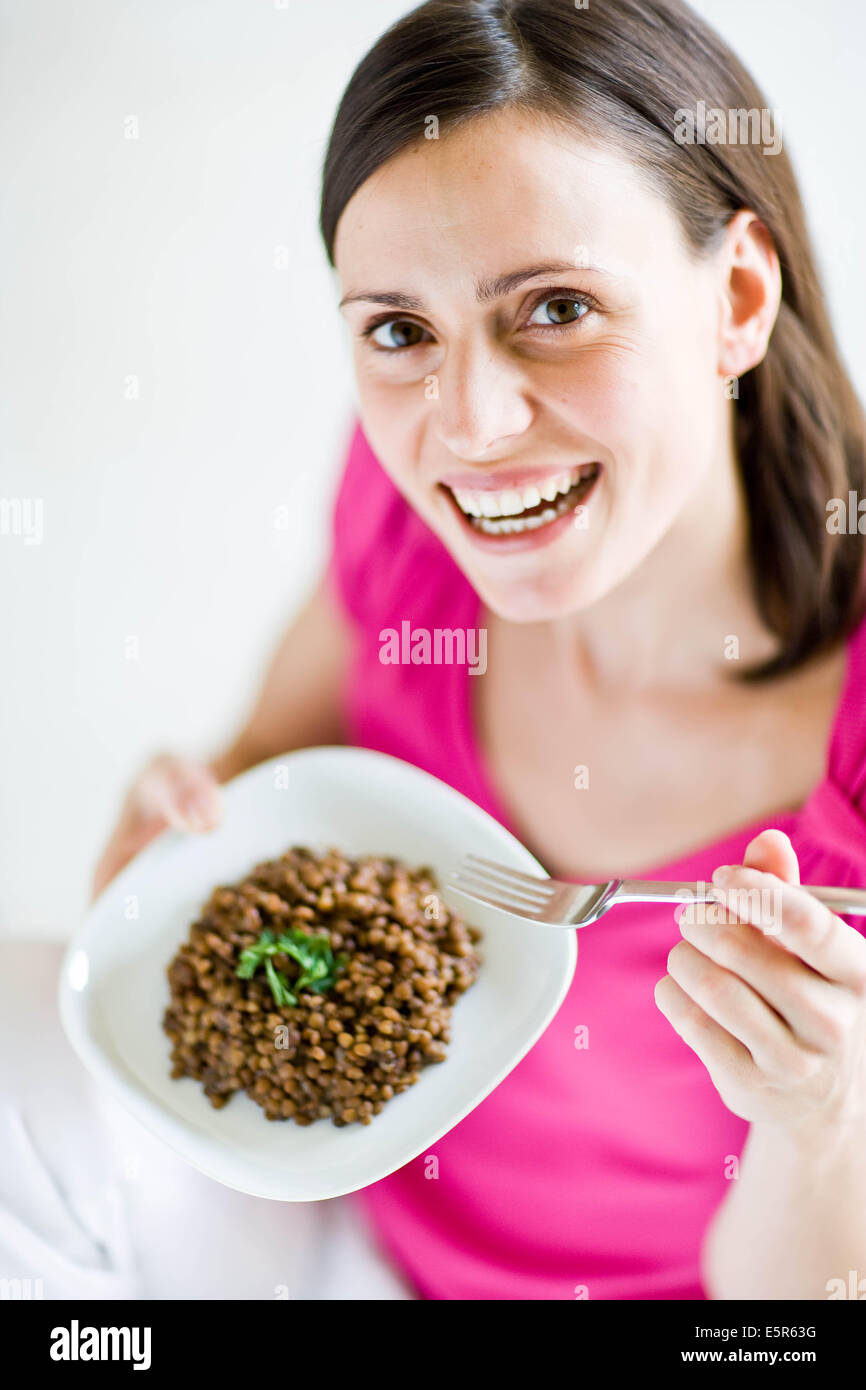 Woman eating lentils Stock Photo - Alamy