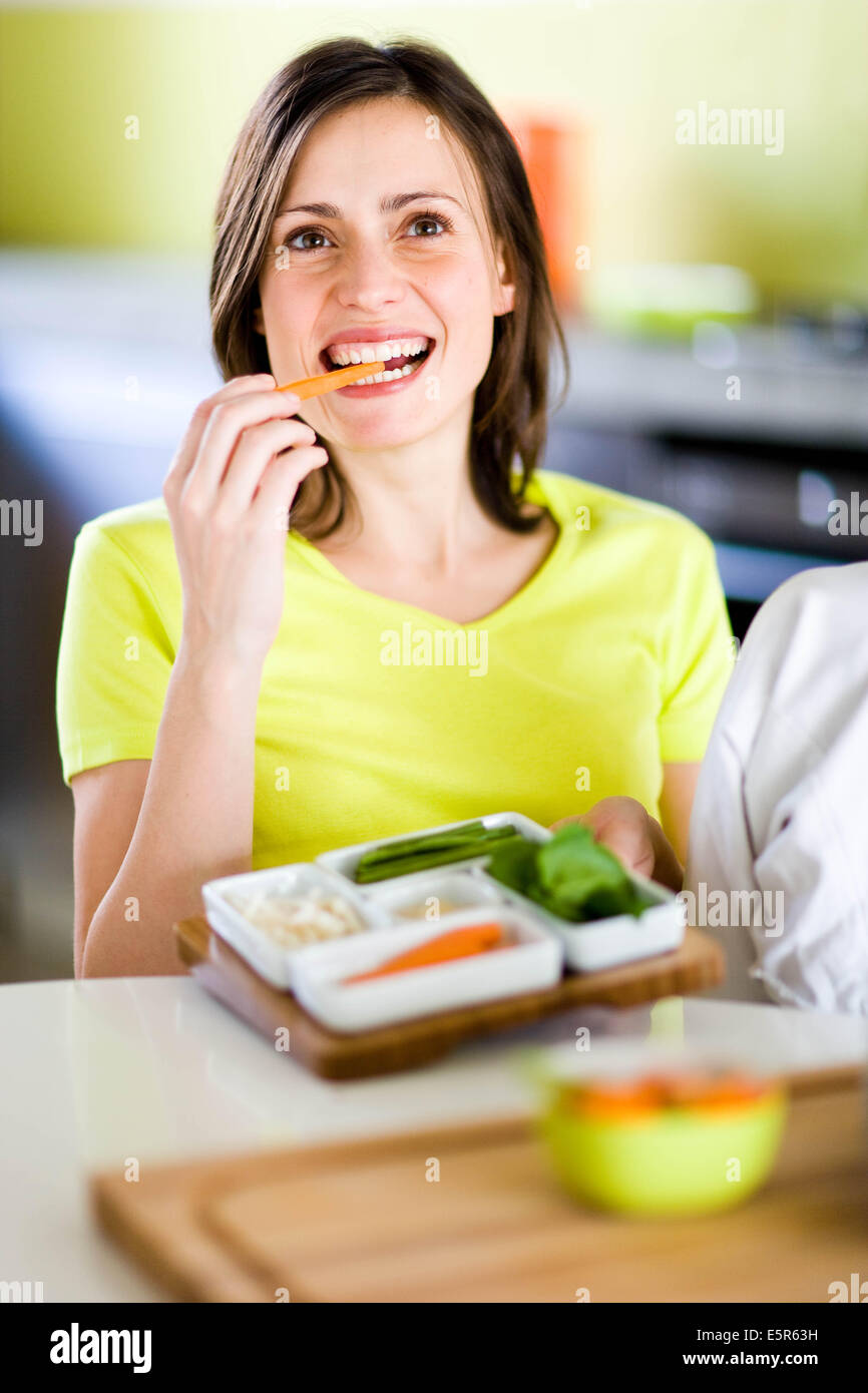 Woman eating carrots Stock Photo - Alamy