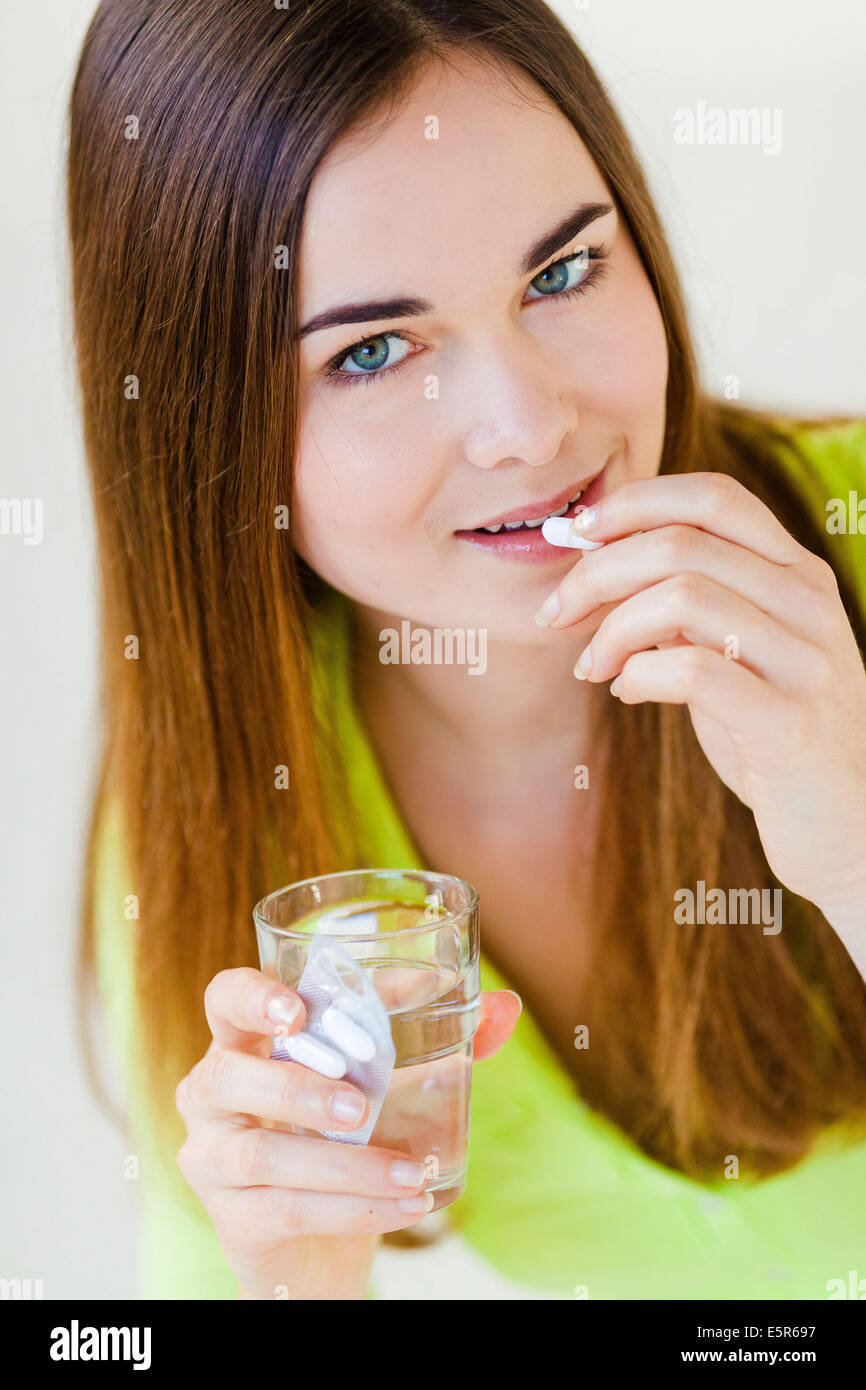 Woman taking capsule Stock Photo - Alamy