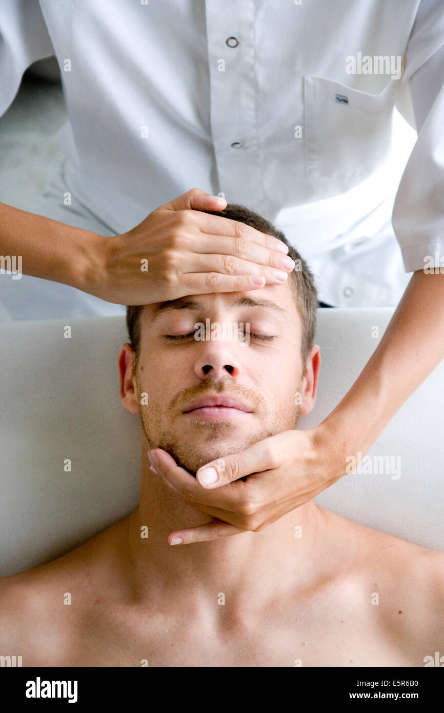 Head and neck of a man being manipulated by osteopath Stock Photo - Alamy