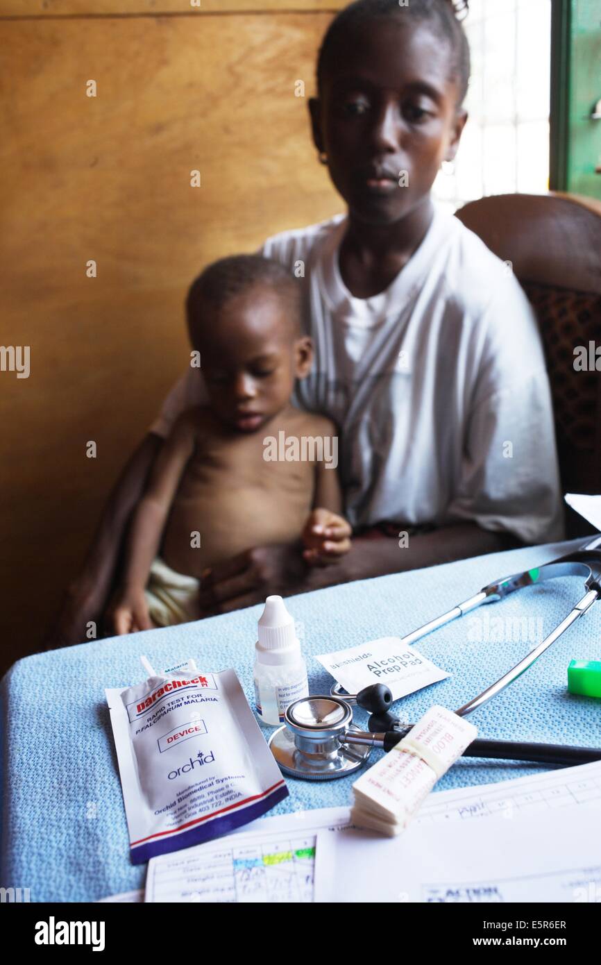 Child suffering from malnutrition receiving malaria test, Program of ...