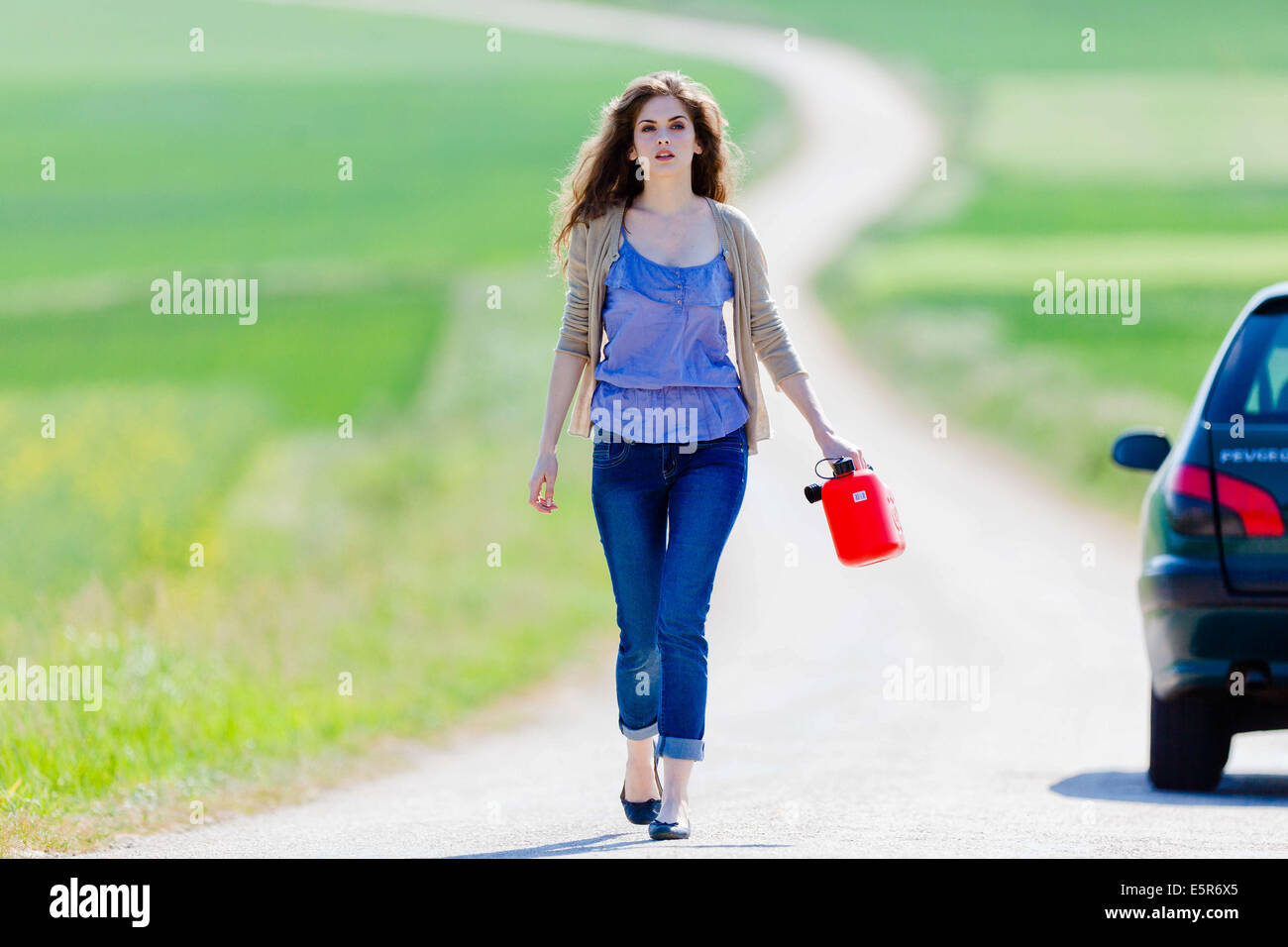 Woman out of gas Stock Photo - Alamy