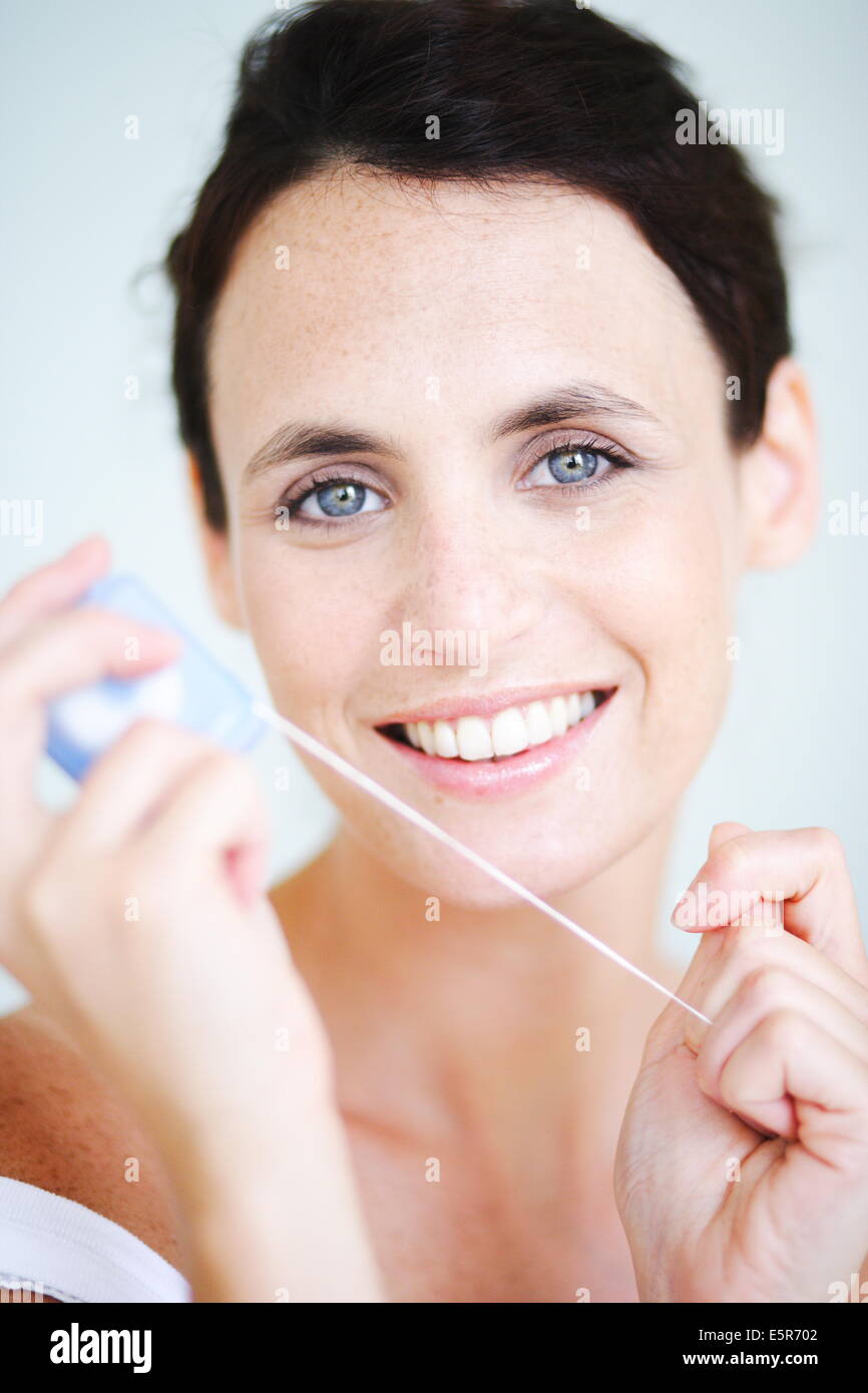 Woman using dental floss Stock Photo - Alamy