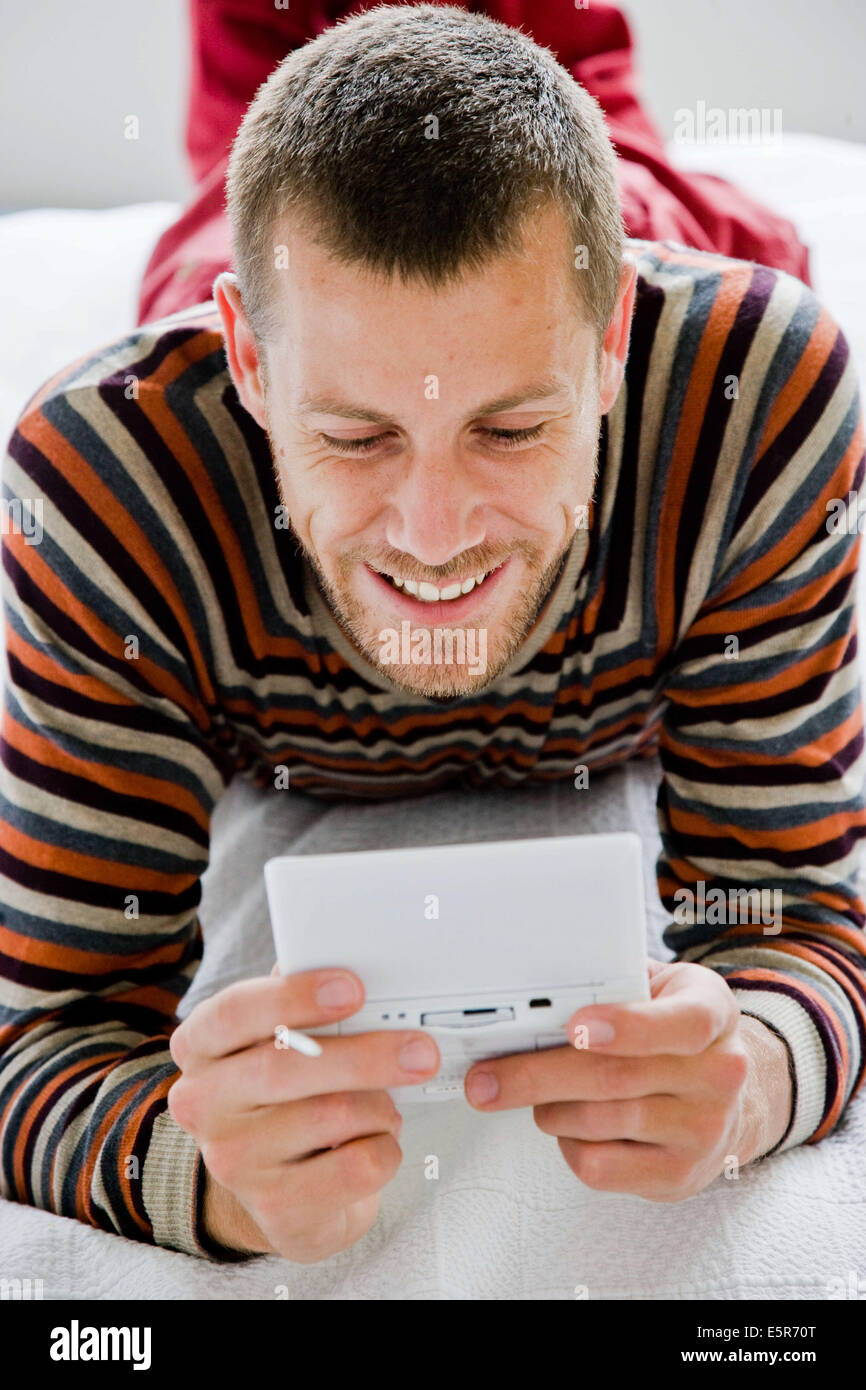 Man playing with a video game console Stock Photo - Alamy