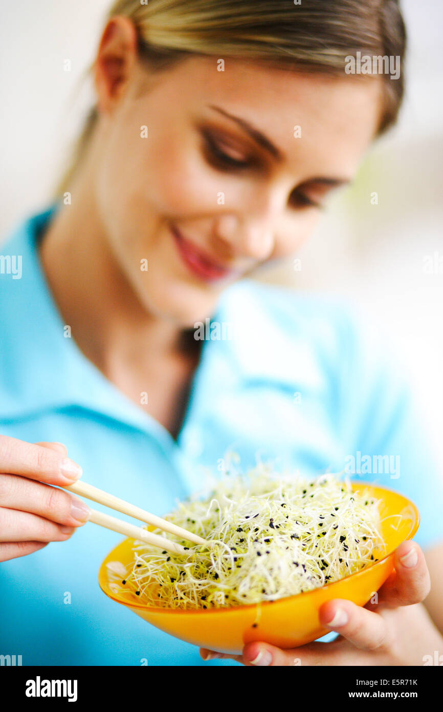 Woman eating sprouts Stock Photo - Alamy