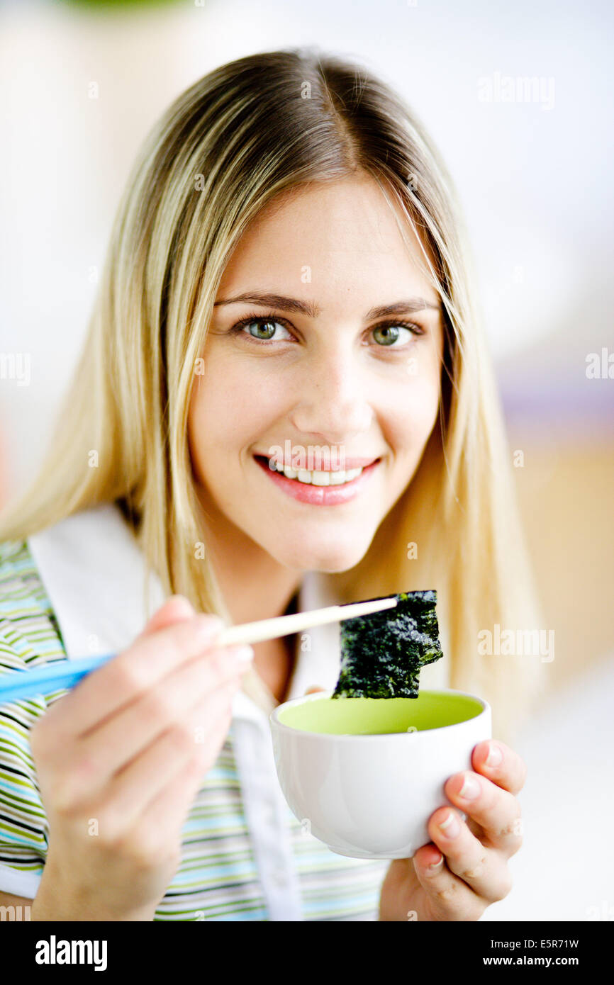 Woman eating edible seaweed Stock Photo - Alamy