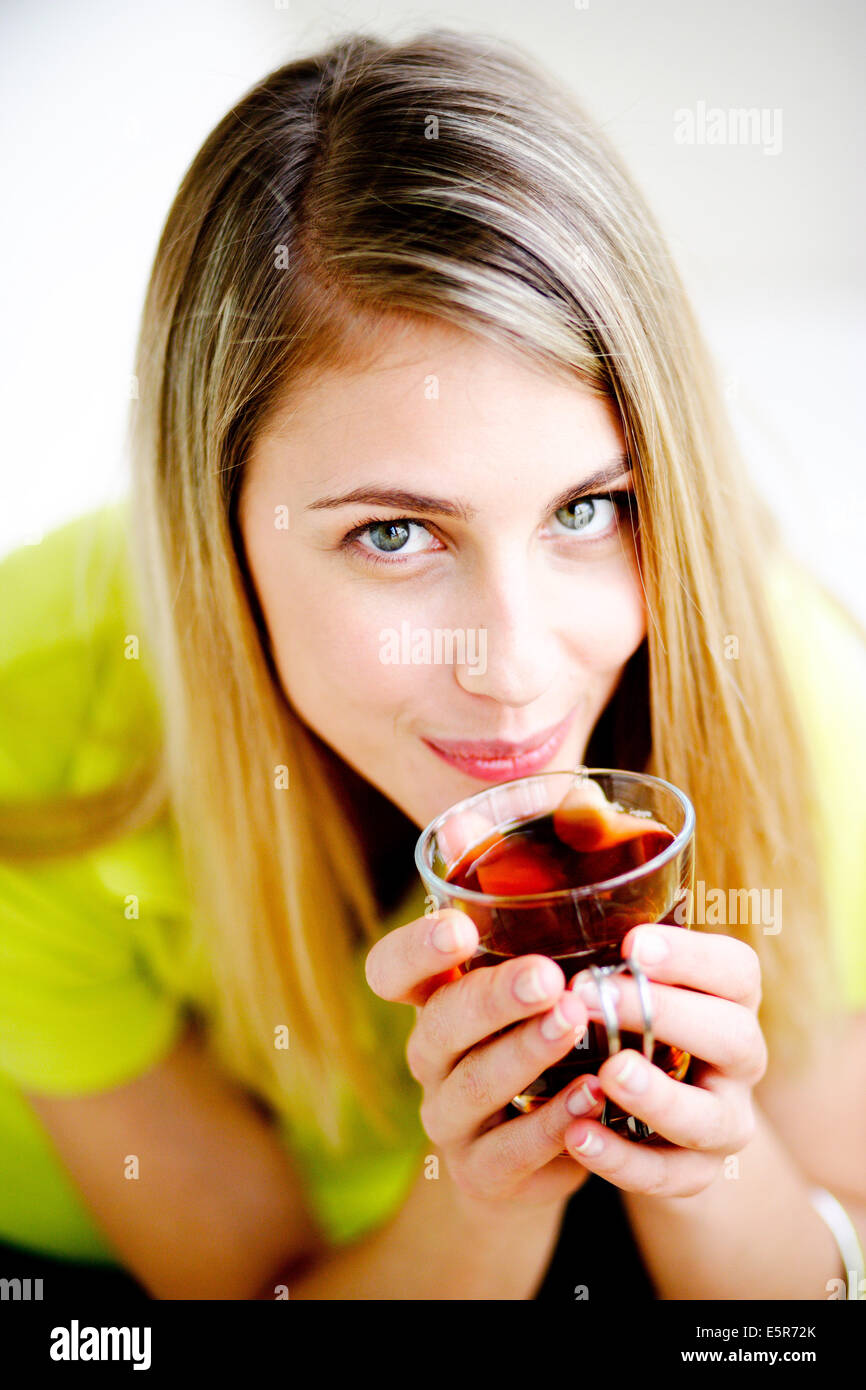 Woman drinking hot beverage Stock Photo - Alamy
