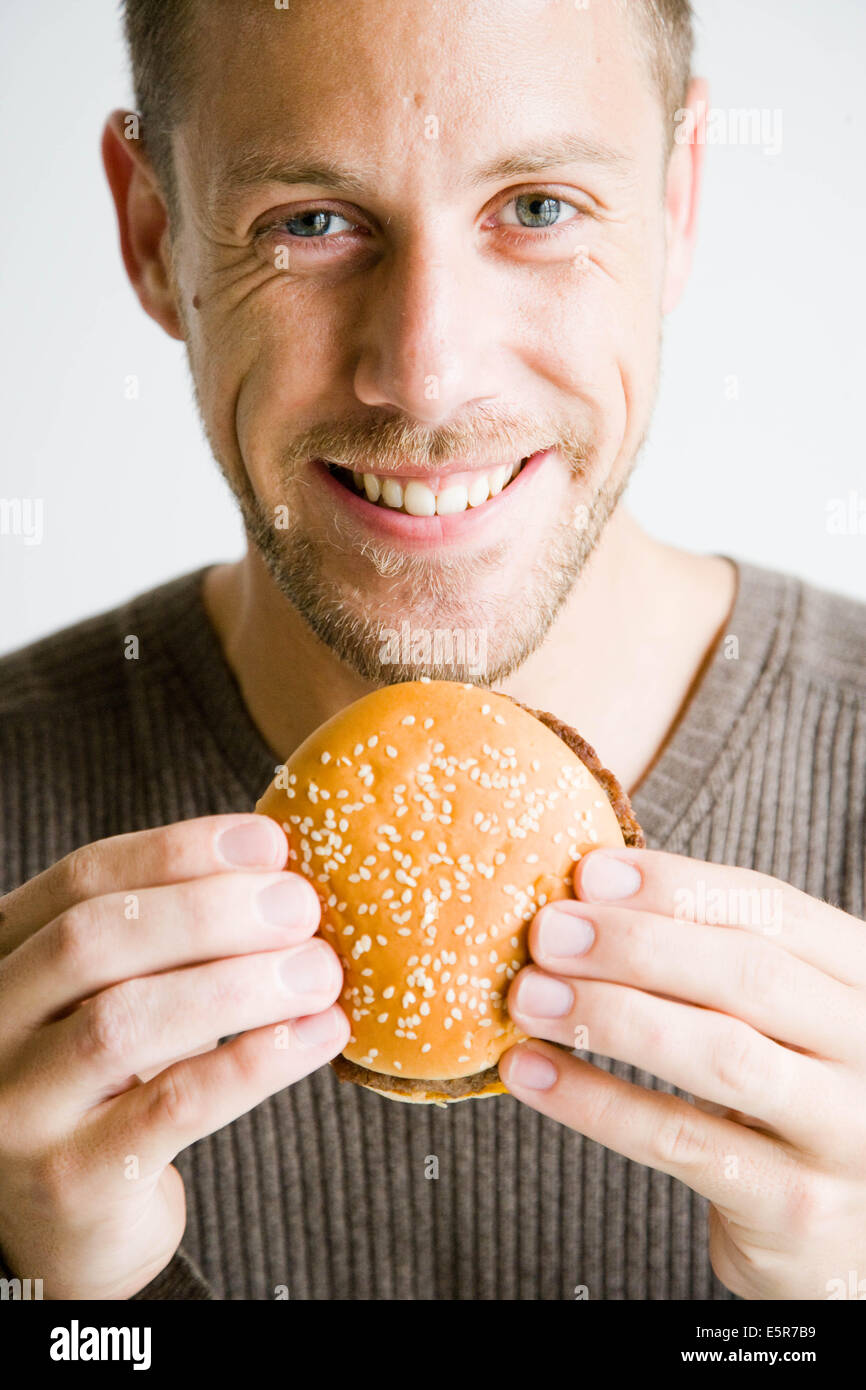 Man eating hamburger Stock Photo - Alamy