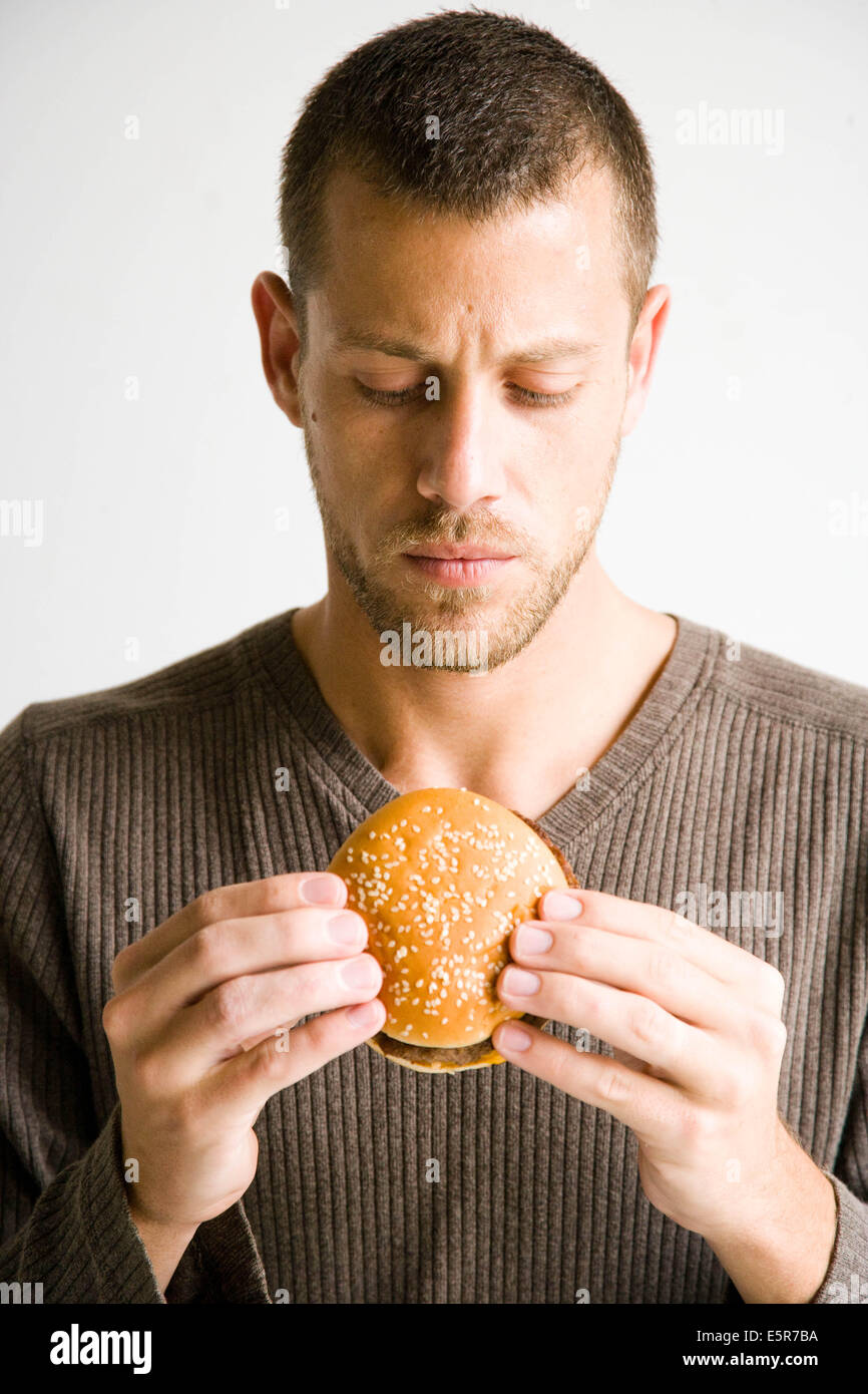 Man eating hamburger Stock Photo - Alamy