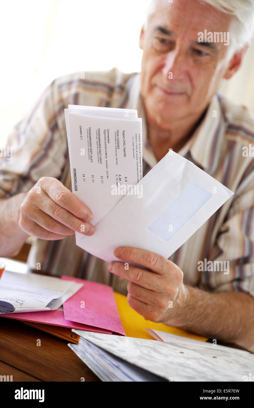 Senior person reading his mail Stock Photo - Alamy