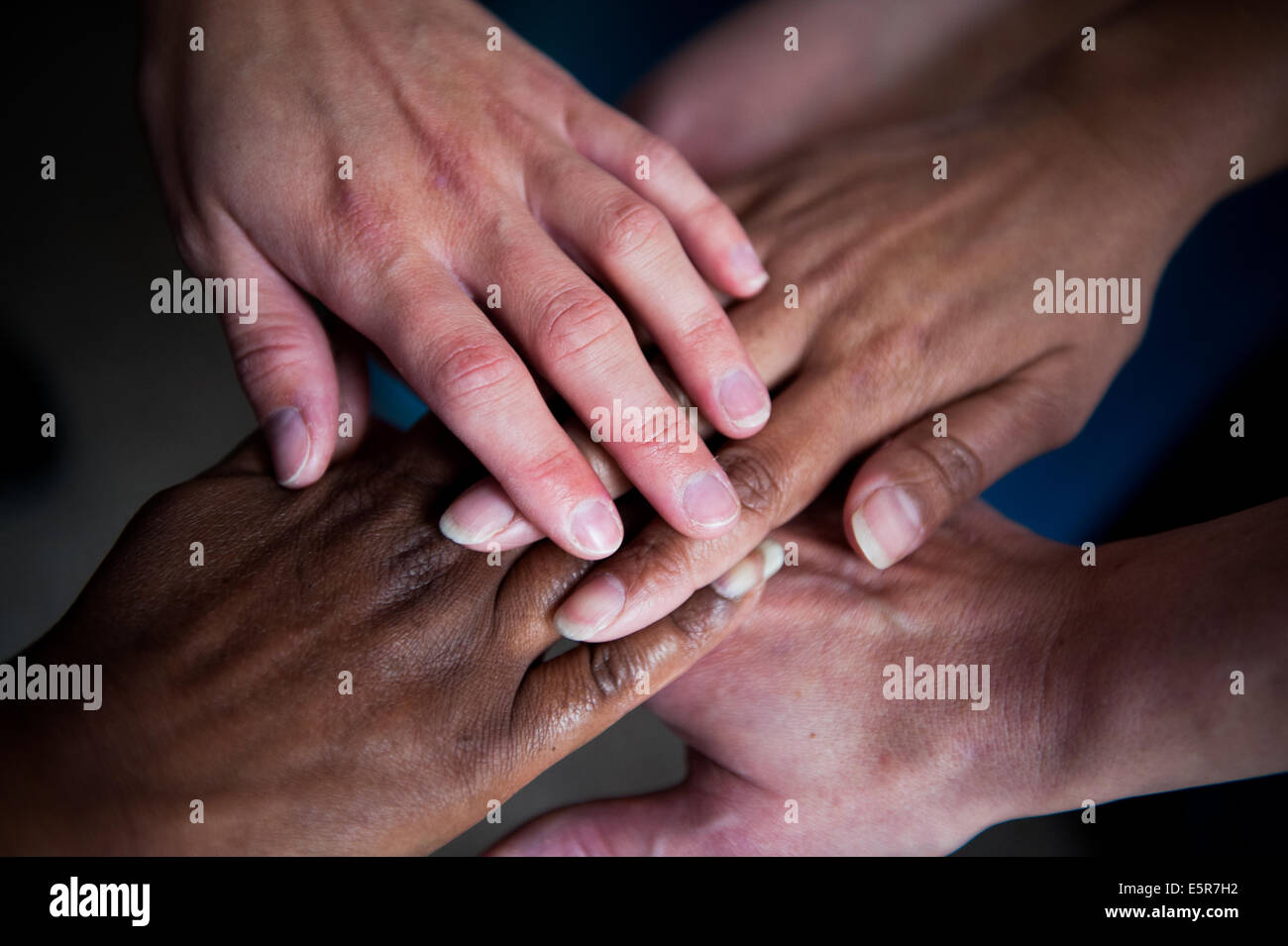 4 peoples hands Stock Photo - Alamy