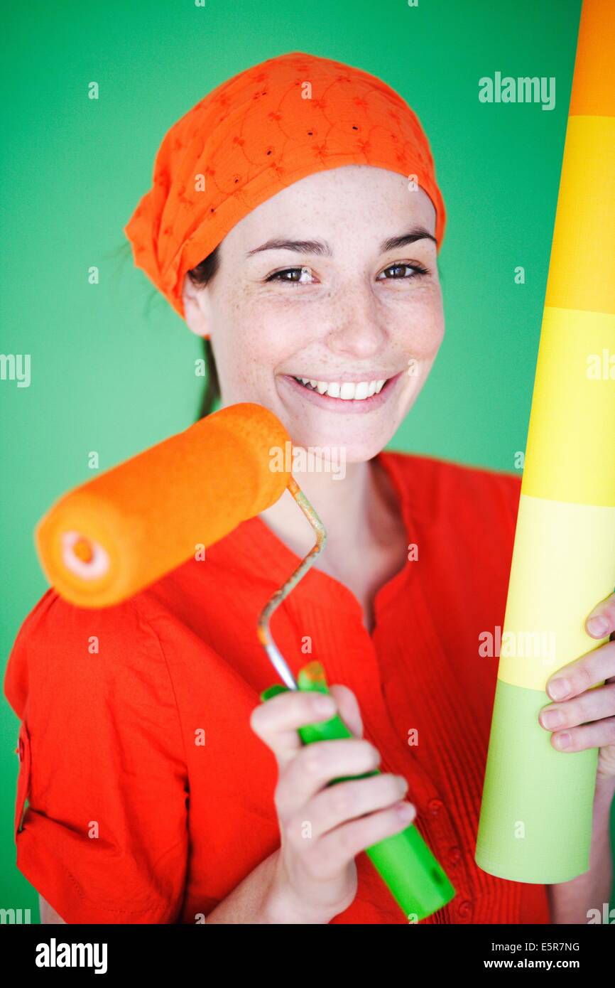 Do-it-yourself, Woman using paint roller Stock Photo - Alamy