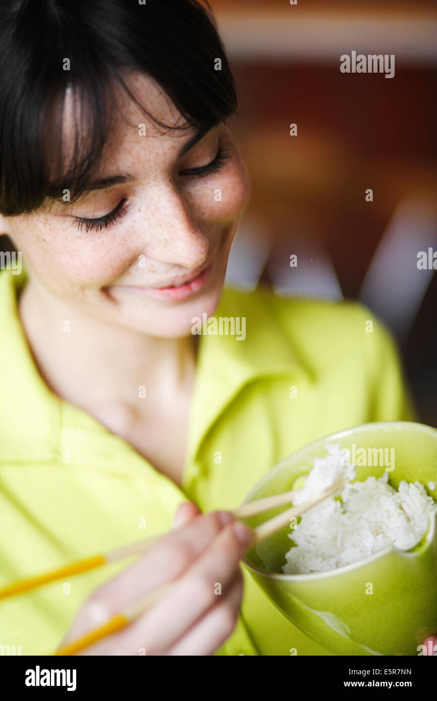 Woman eating rice Stock Photo - Alamy