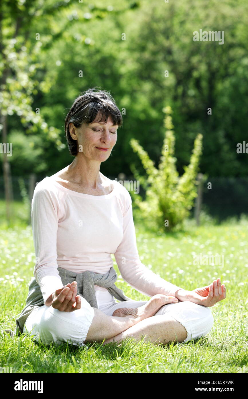Woman practicing yoga Stock Photo - Alamy