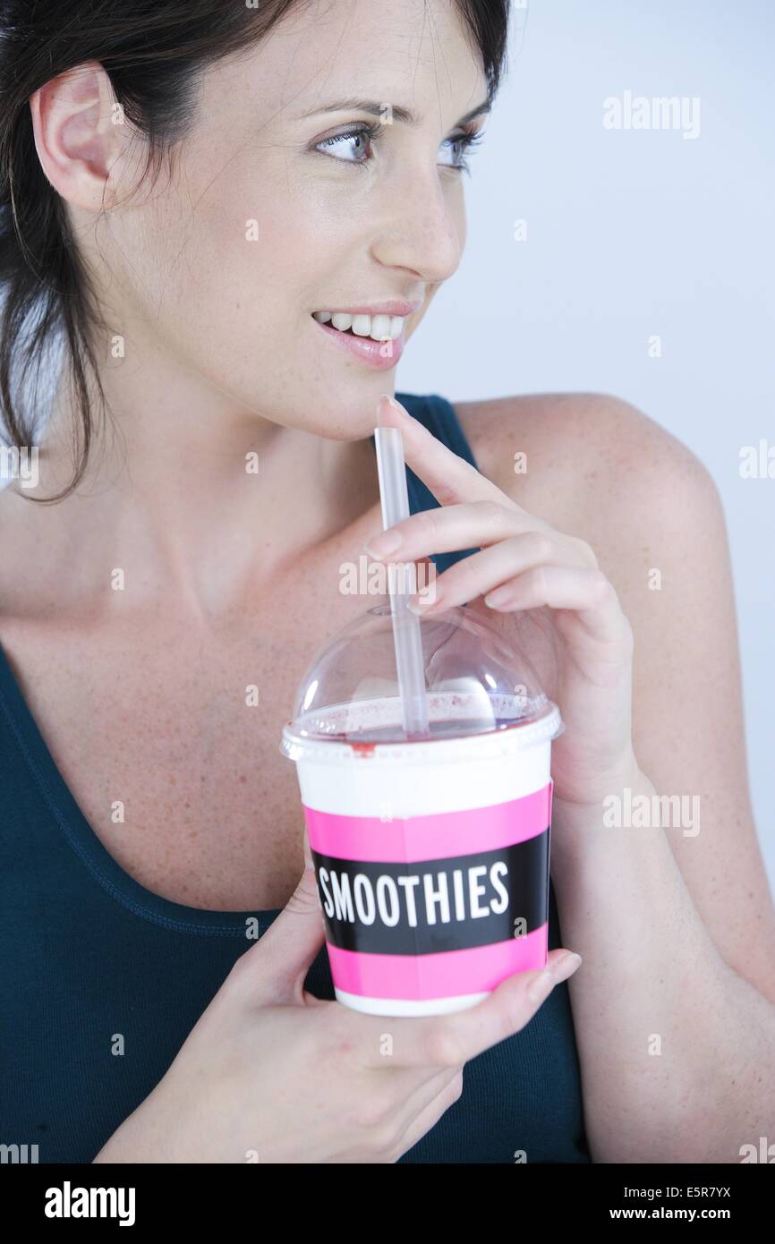 Woman drinking a smoothie Stock Photo - Alamy