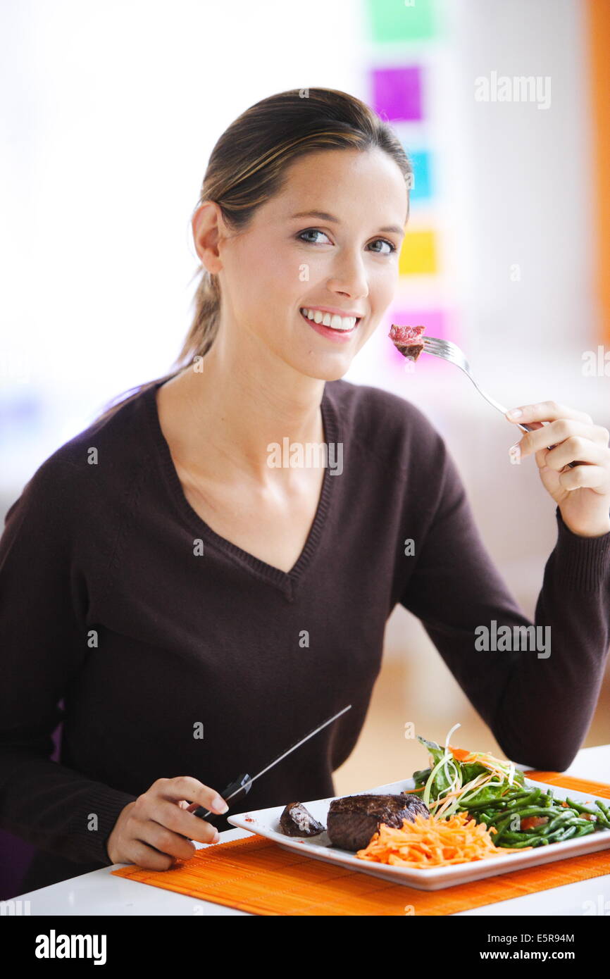 Woman having lunch Stock Photo - Alamy