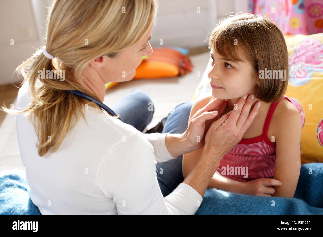 Doctor examining the lymph nodes of 7 year old girl Stock Photo - Alamy