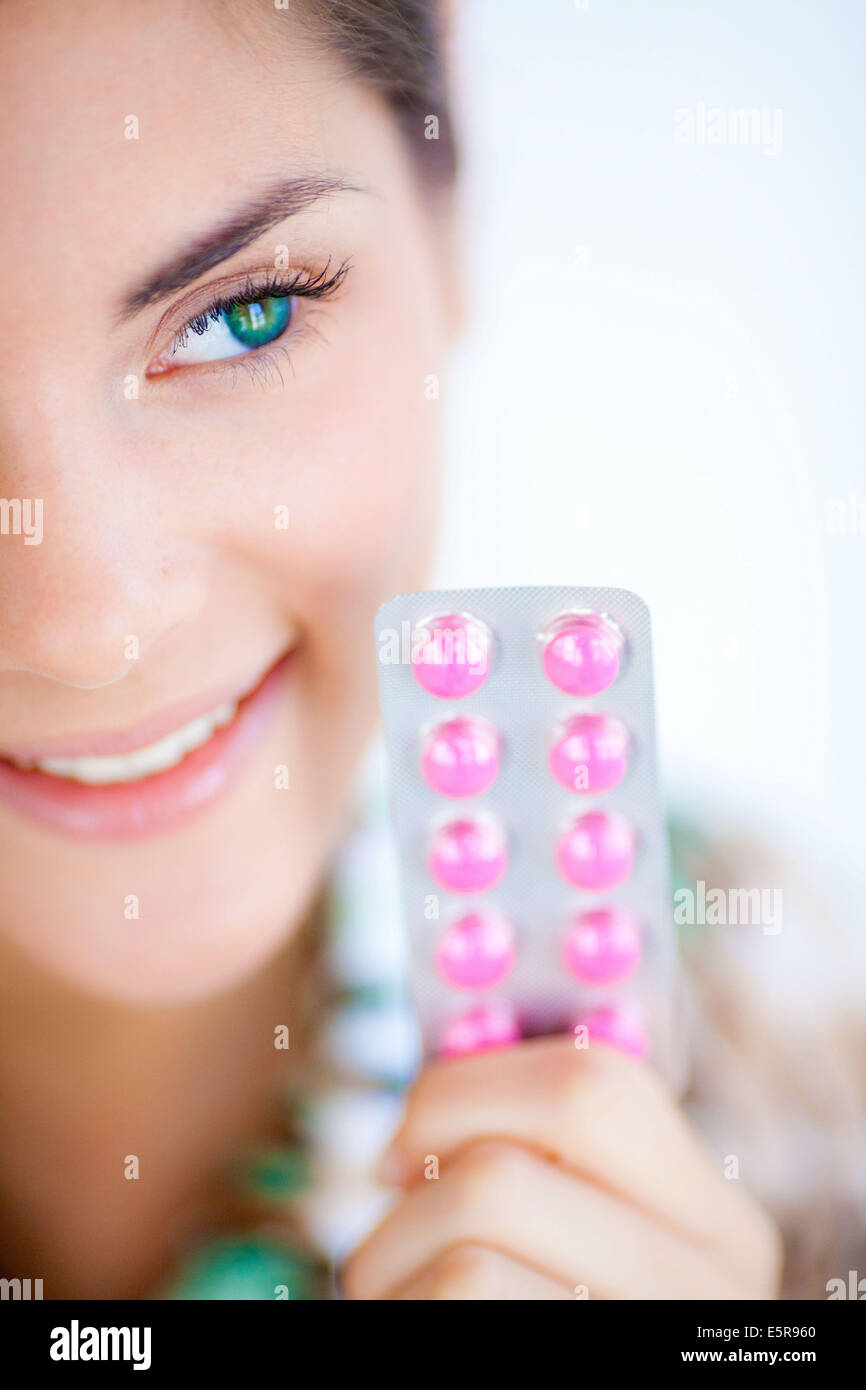 Woman taking tablets Stock Photo - Alamy