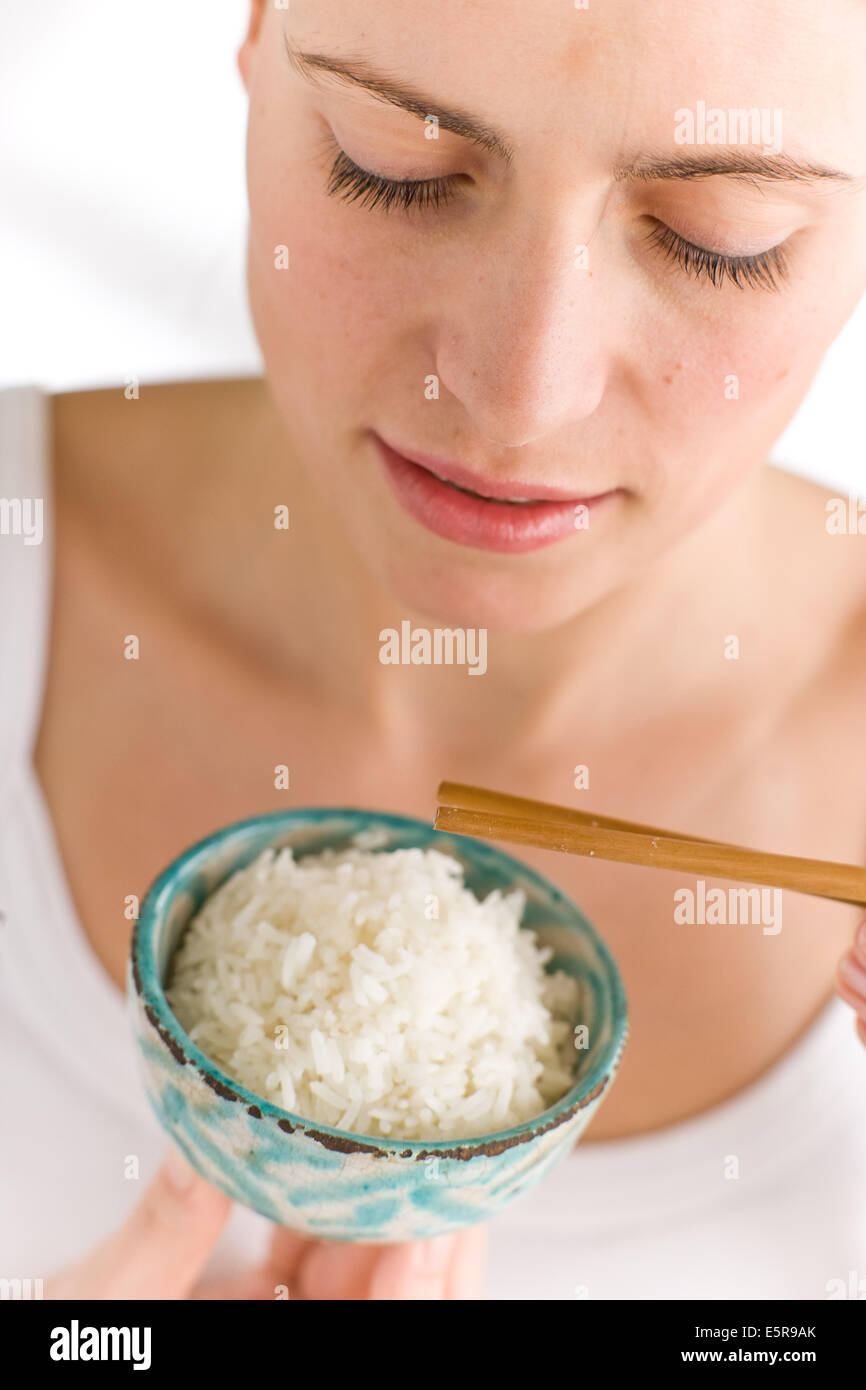 Woman eating rice Stock Photo - Alamy