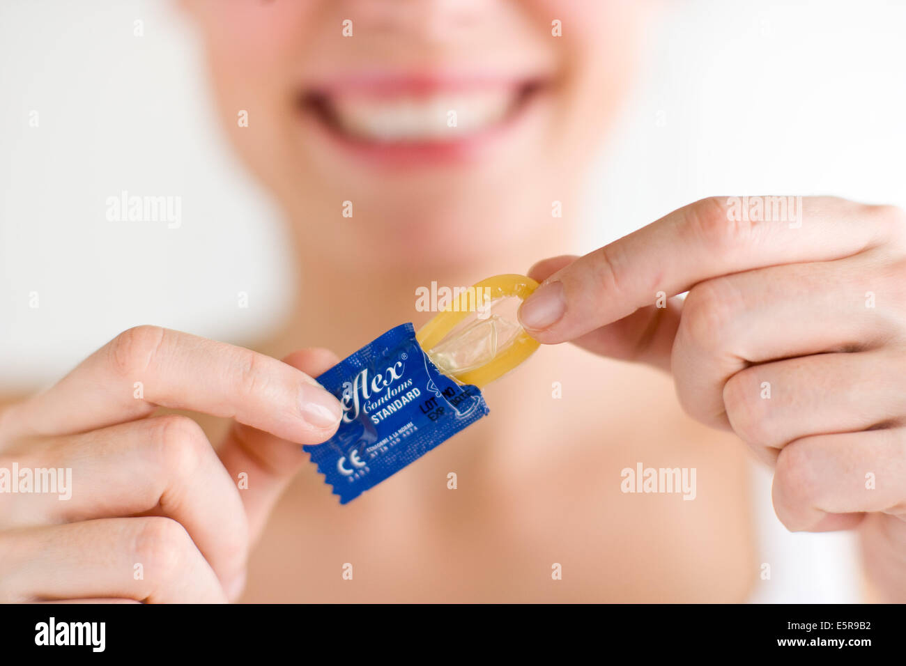 Woman holding a condom Stock Photo - Alamy
