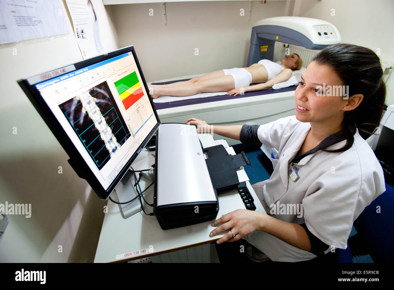 A Doctor Uses A Bone Densitometer To Measure The Optical Density Of The
