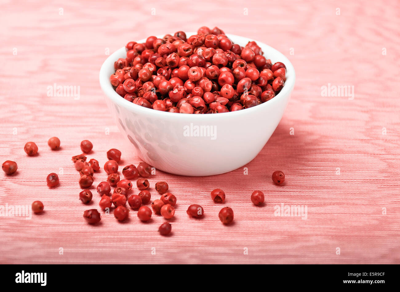Pink Pepper - Dried pink peppercorns in a white porcelain bowl on pink ...