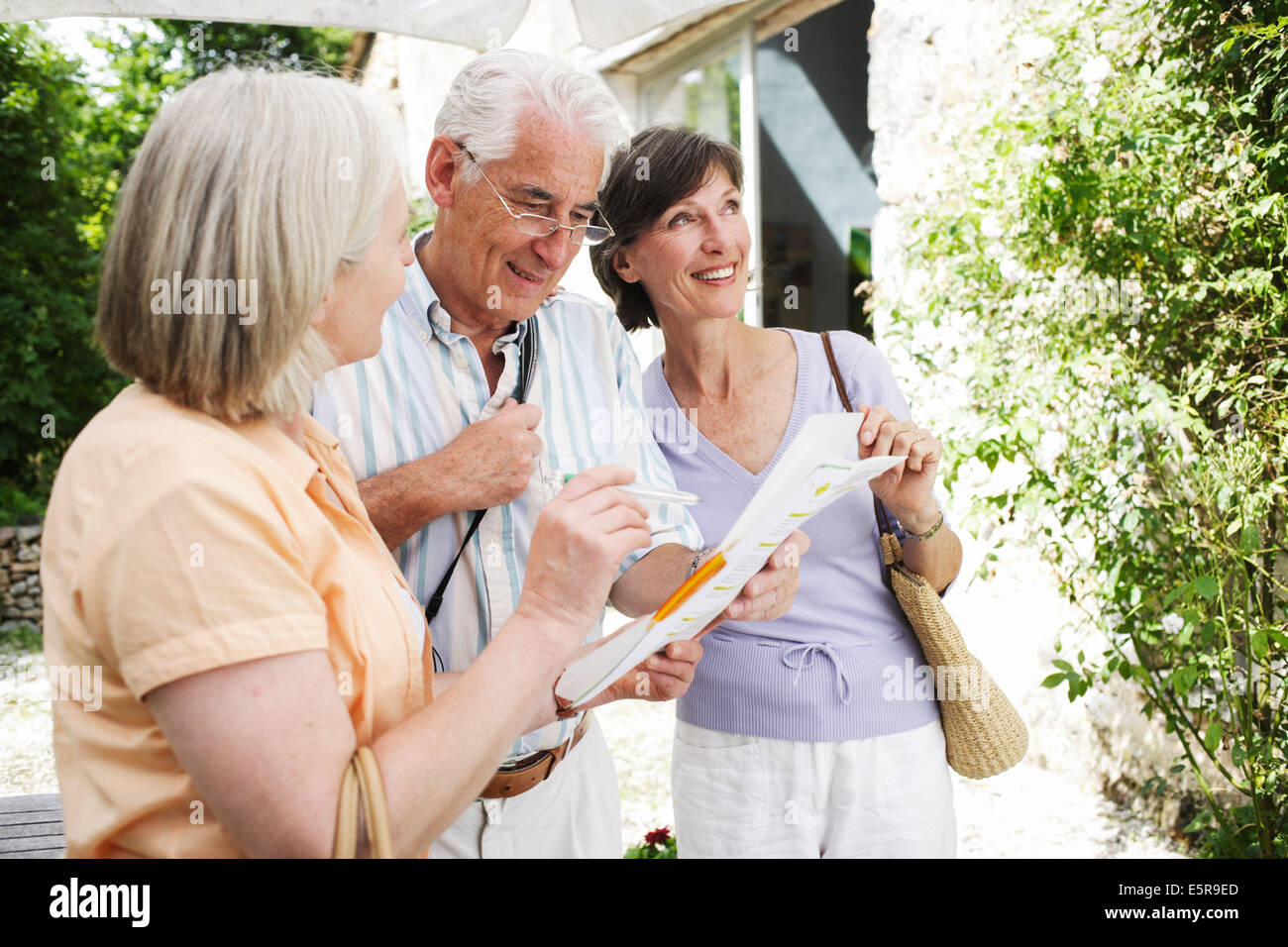 Senior couple with a real estate agent Stock Photo - Alamy