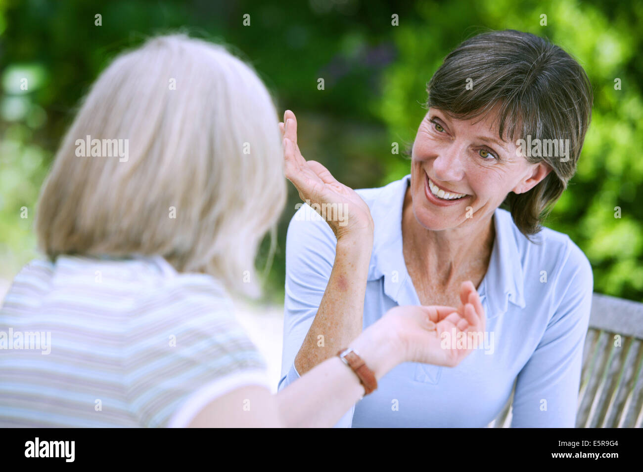 Two senior women talking Stock Photo - Alamy