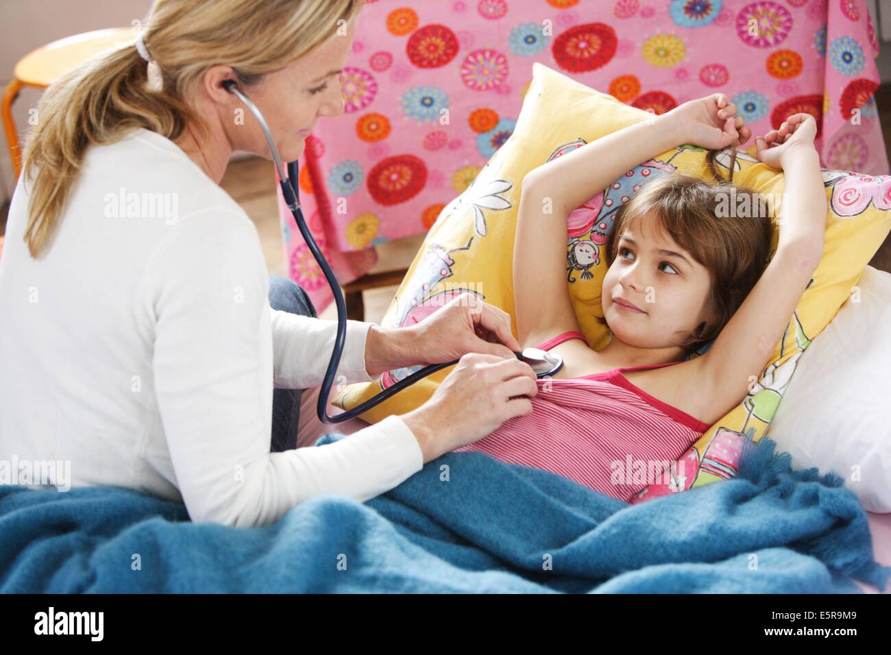 Doctor examining a 7 year old girl with a stethoscope Stock Photo ...