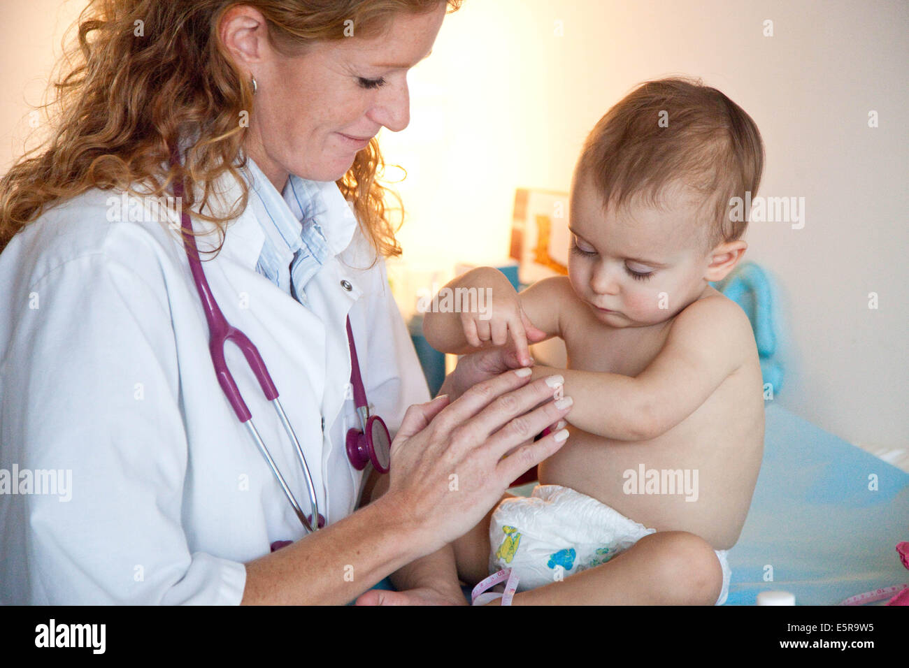 Pediatrician examining the skin of 15 month old baby Stock Photo - Alamy