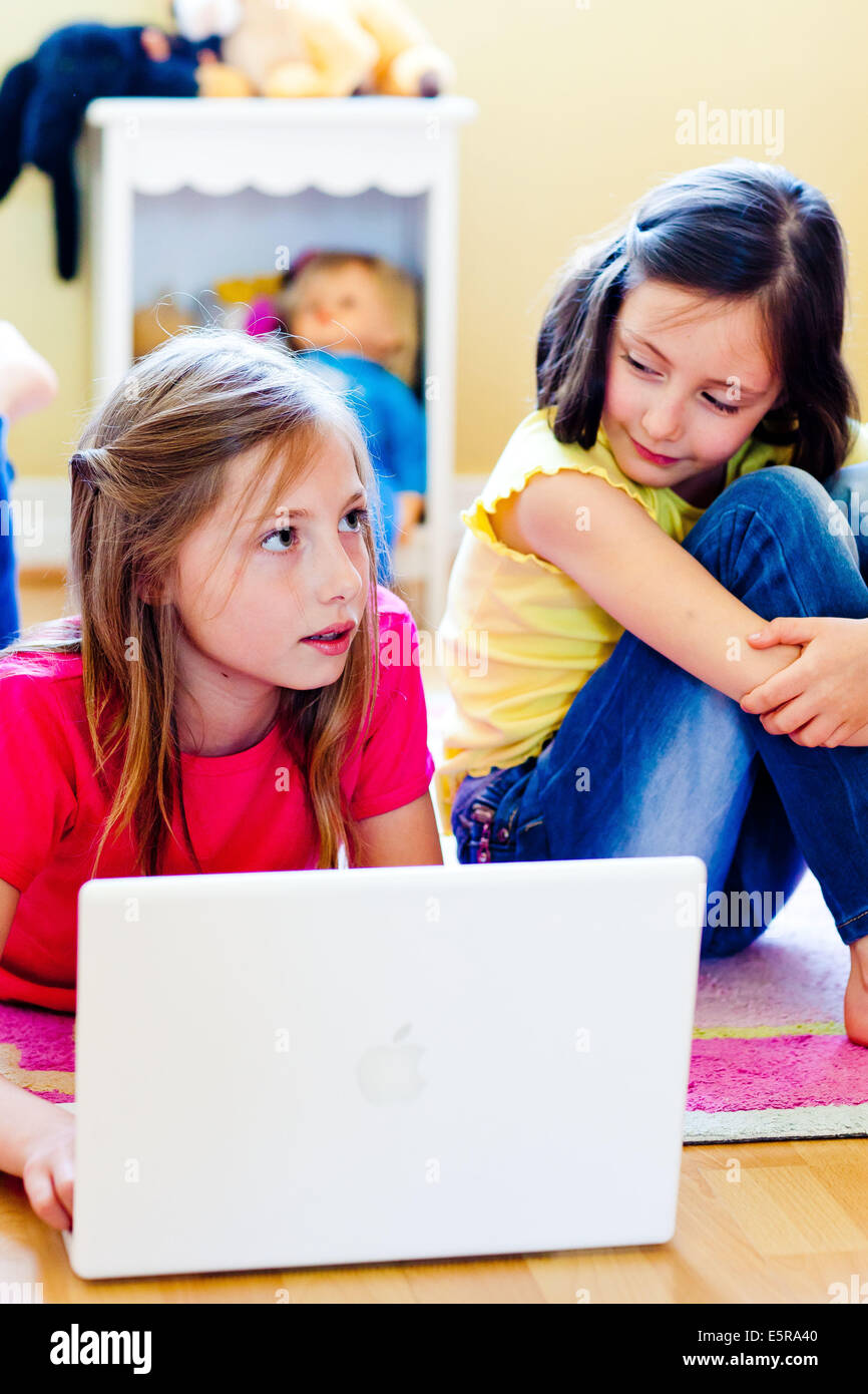 7 and 11-year-old sisters using laptop computer Stock Photo - Alamy
