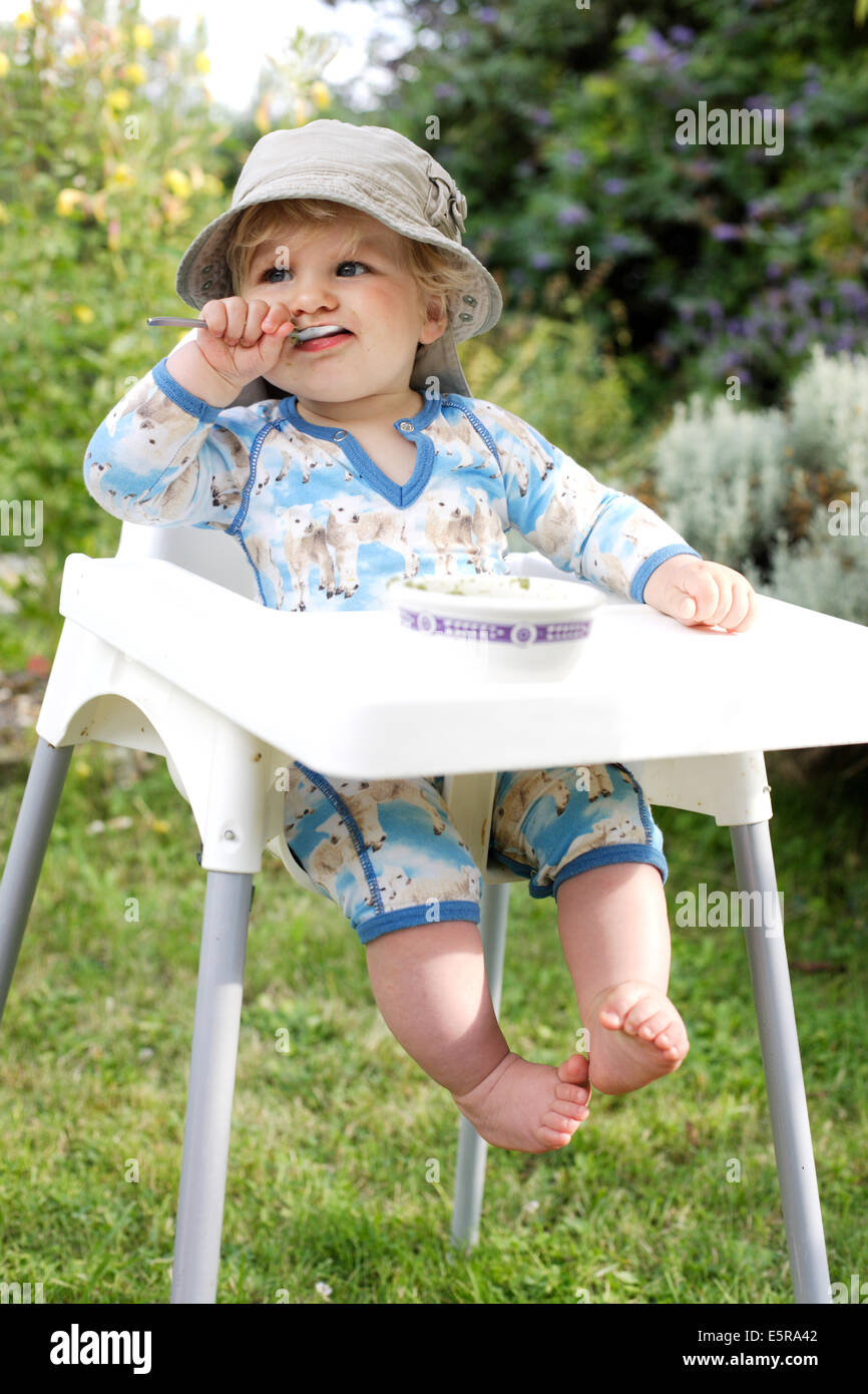 10 month old baby eating alone, Independence training Stock Photo - Alamy
