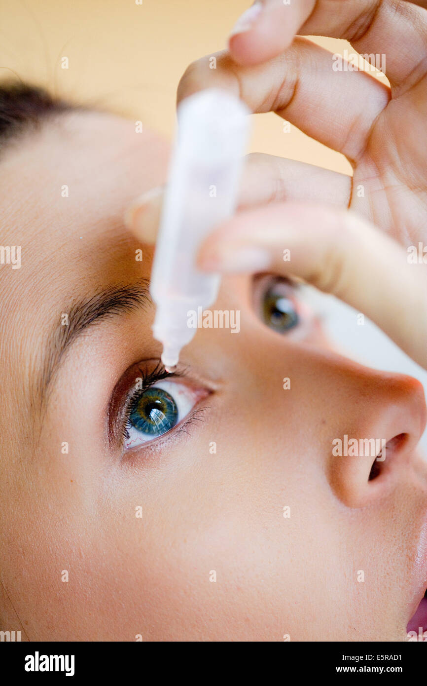 Woman applying eye drops Stock Photo - Alamy