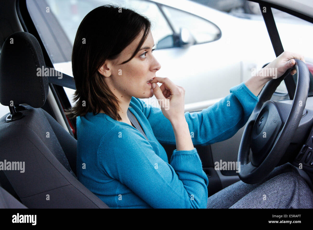 Stressed driver bitting her nails Stock Photo - Alamy