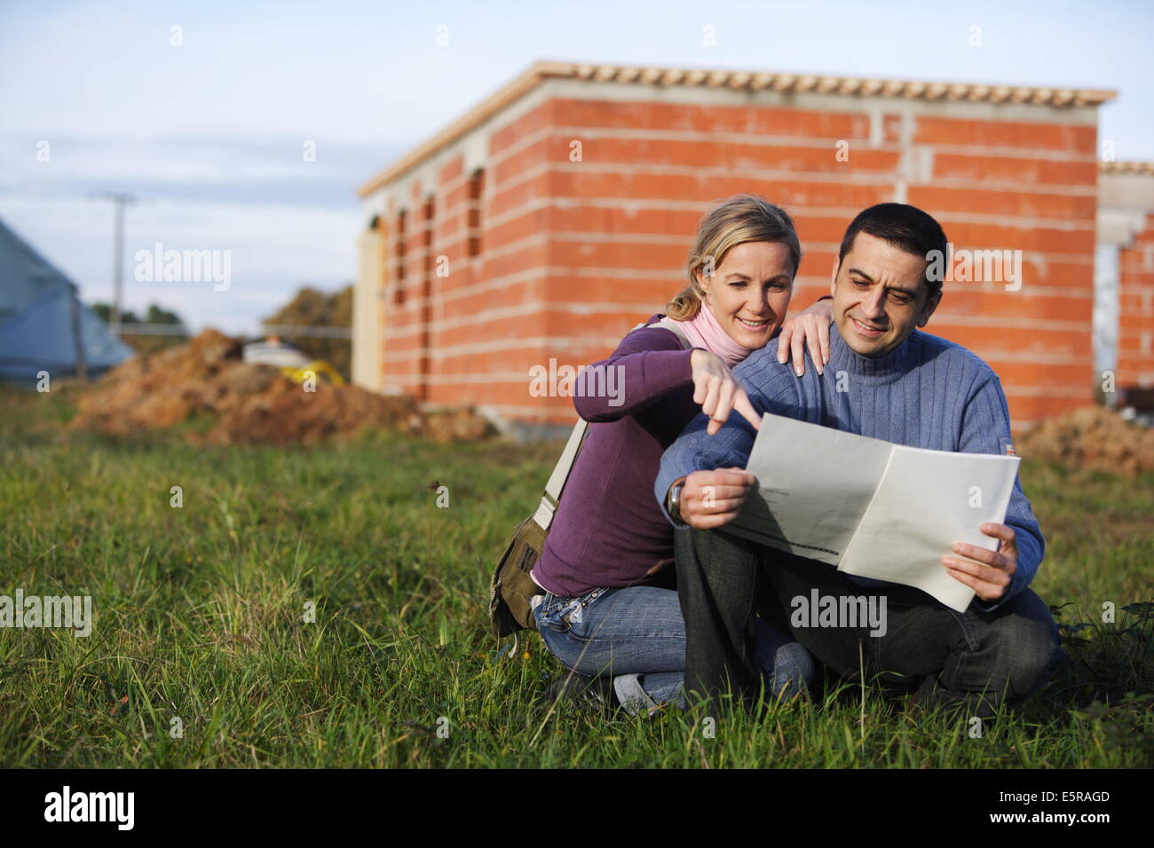 Couple visiting the building site of their future house Stock Photo - Alamy