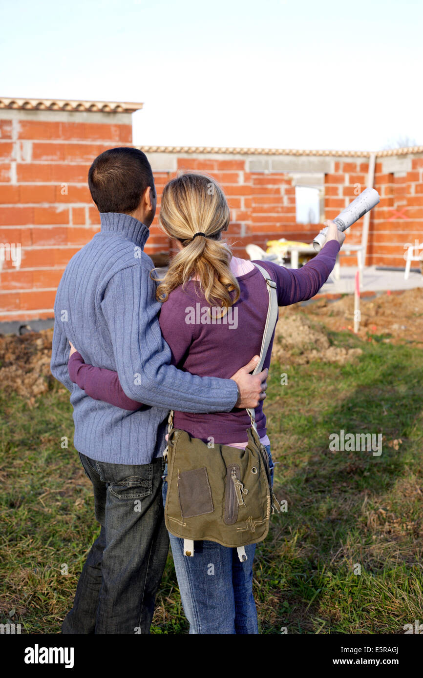 Couple visiting the building site of their future house Stock Photo - Alamy