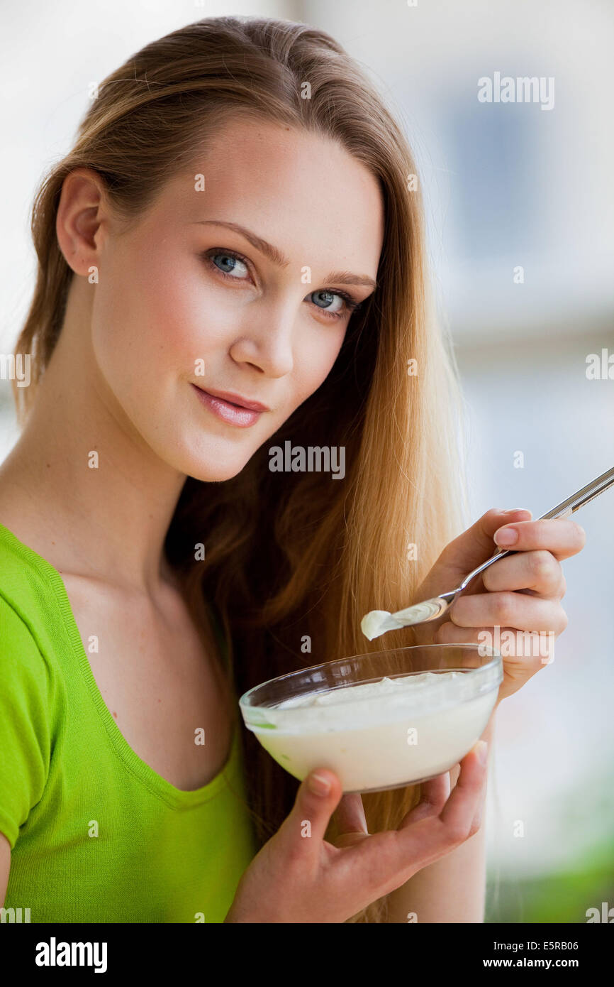 Woman eating cottage cheese Stock Photo - Alamy