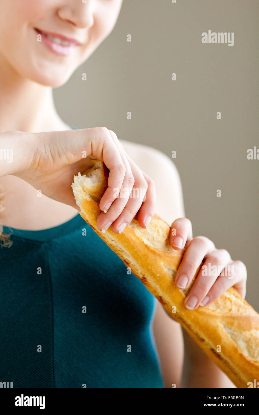 Woman eating bread Stock Photo - Alamy