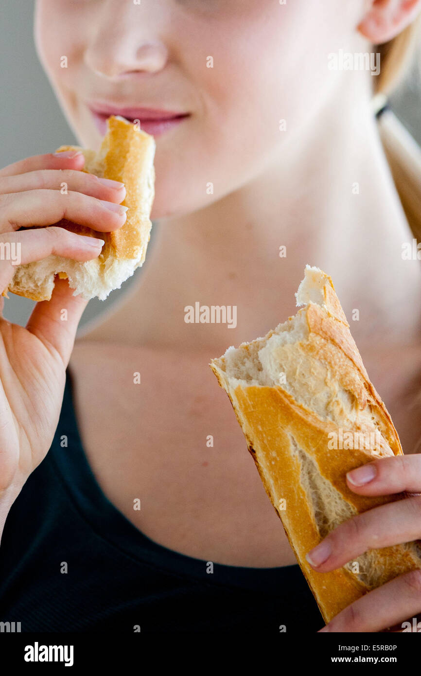 Woman eating bread Stock Photo - Alamy