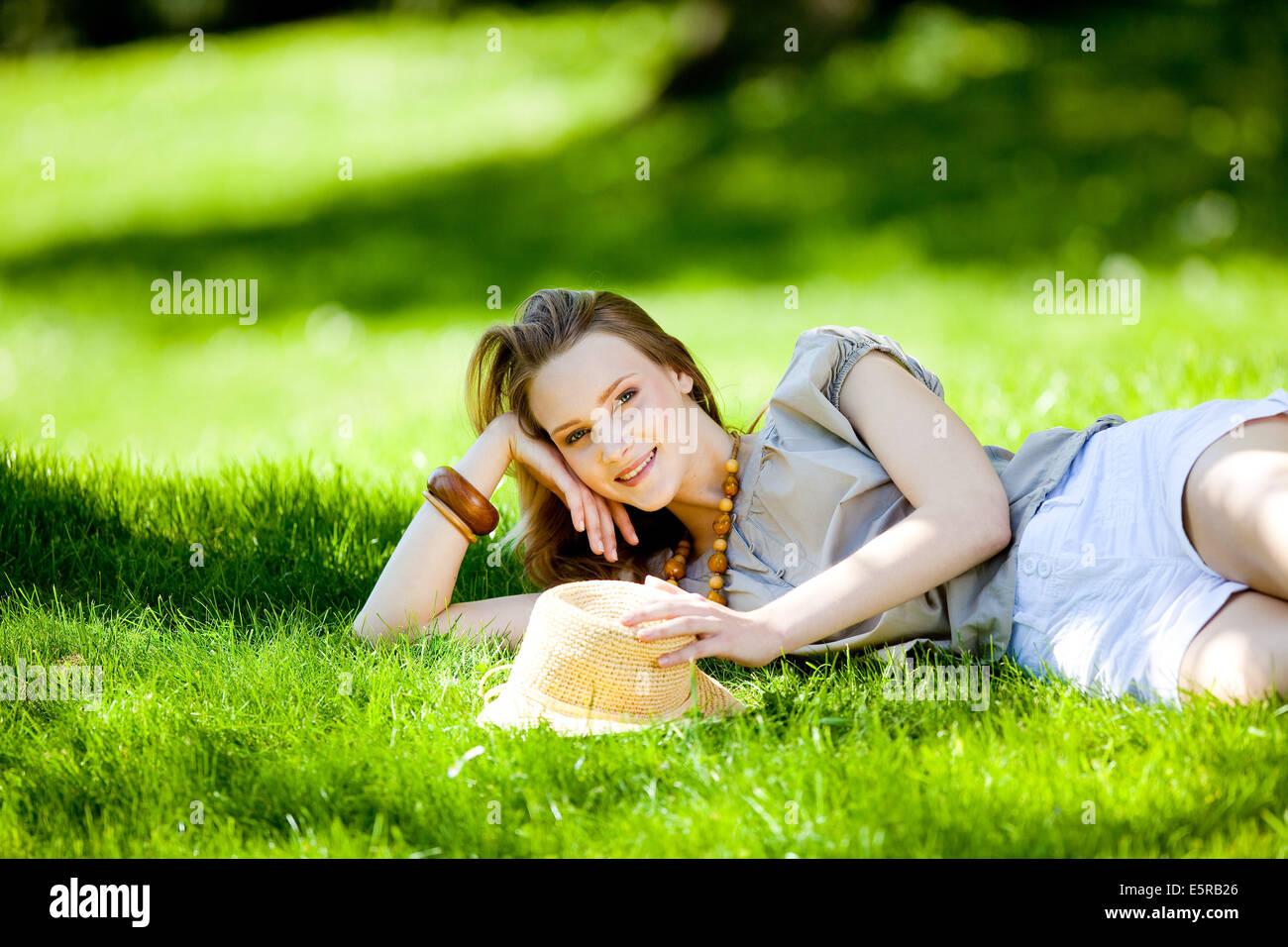 Woman relaxing on grass Stock Photo - Alamy