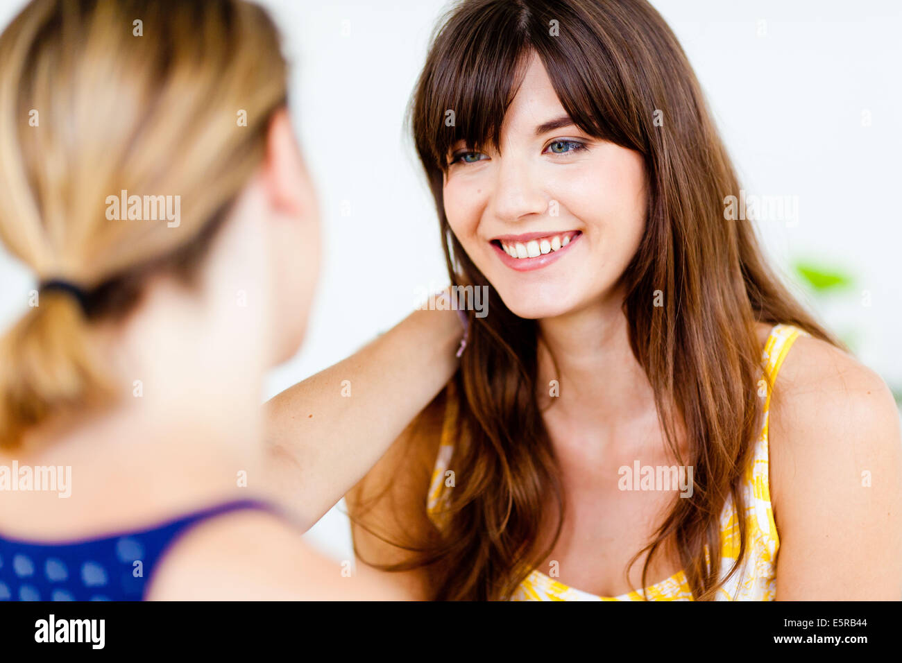Young women talking Stock Photo - Alamy