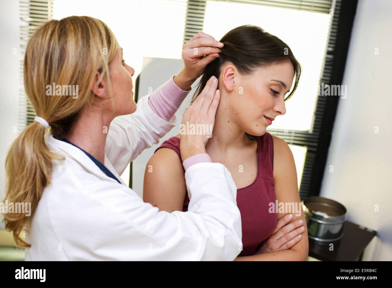 Doctor examining the scalp and skin of a patient Stock Photo - Alamy